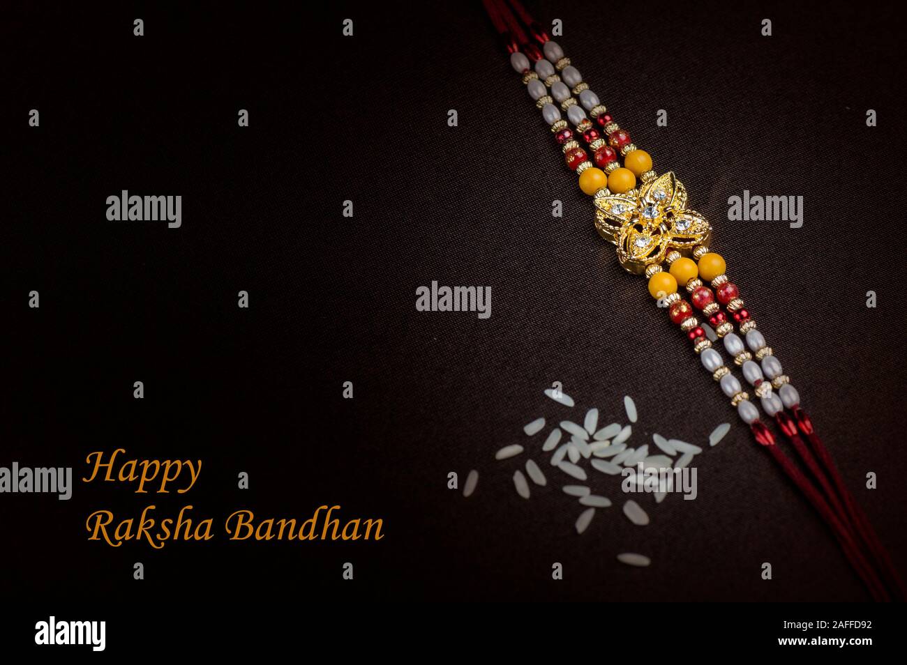 Raksha Bandhan background with an elegant Rakhi. A traditional Indian ...