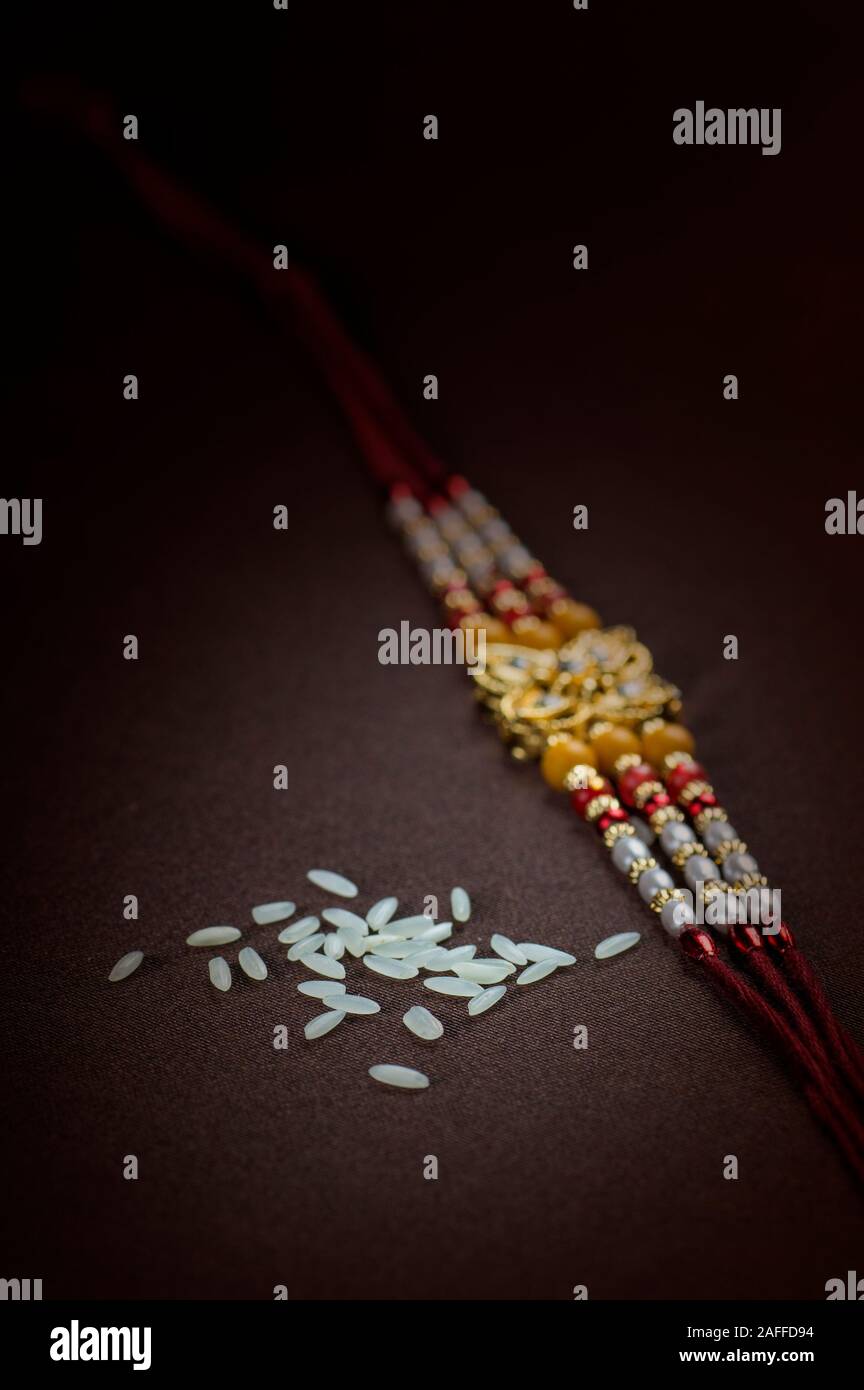 Raksha Bandhan background with an elegant Rakhi. A traditional Indian ...