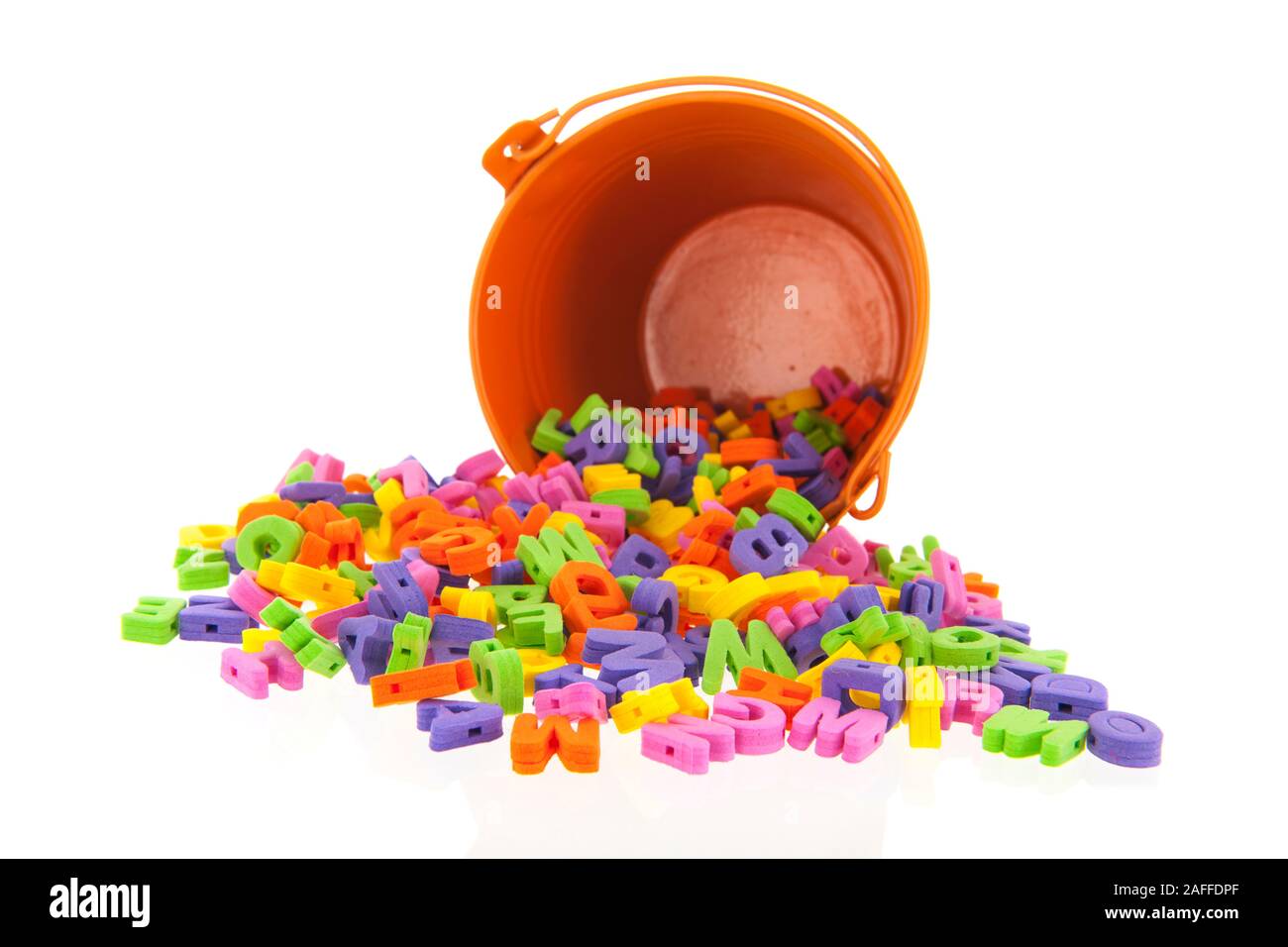 Fallen orange bucket with many foam letters isolated over white ...