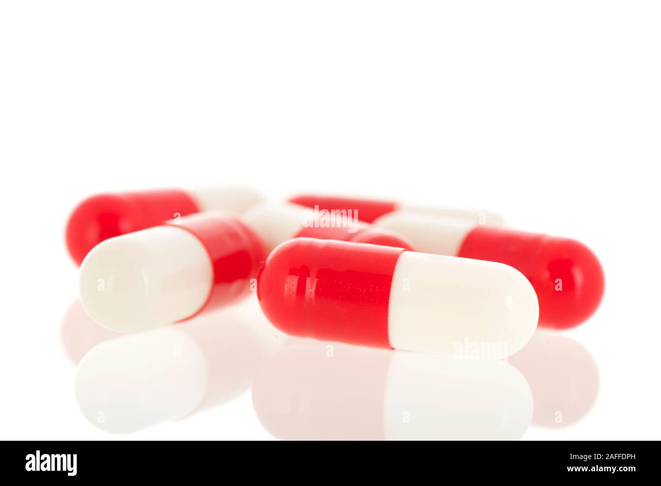 Red and white capsule pills isolated over white background Stock Photo ...