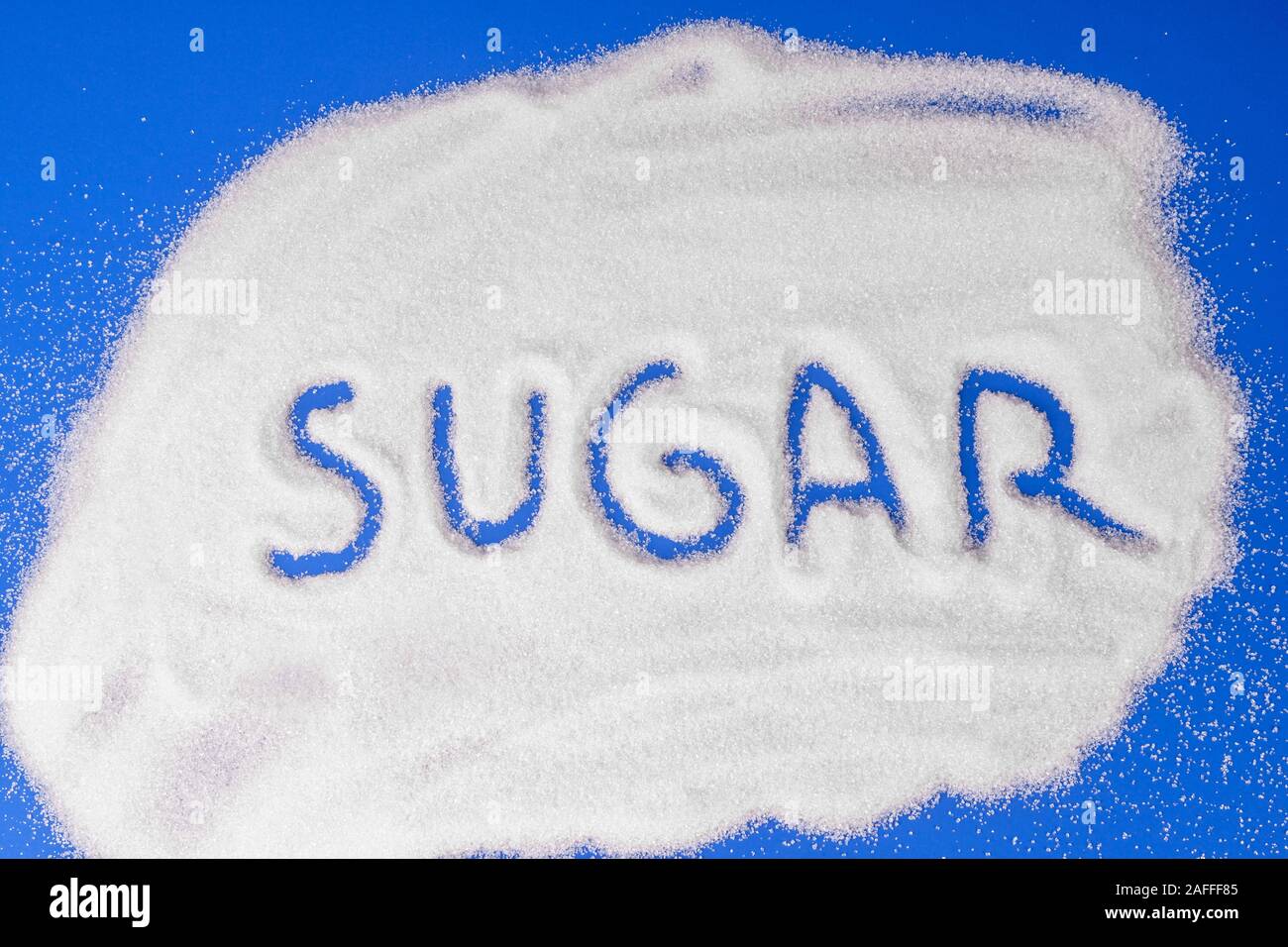 The word sugar written in sugar grains Stock Photo - Alamy