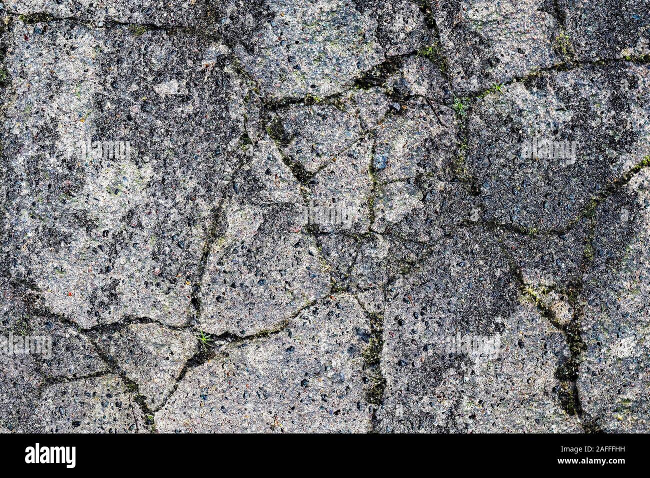Detailed close up view on aged and cracked asphalt on roads in northern ...