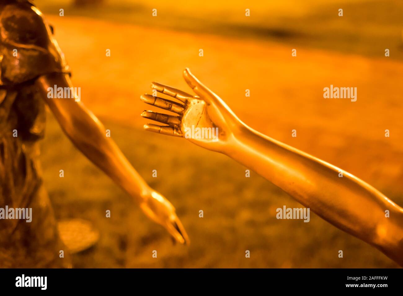 A fragment, the hand of a statue, a bronze hand reaching out to another ...