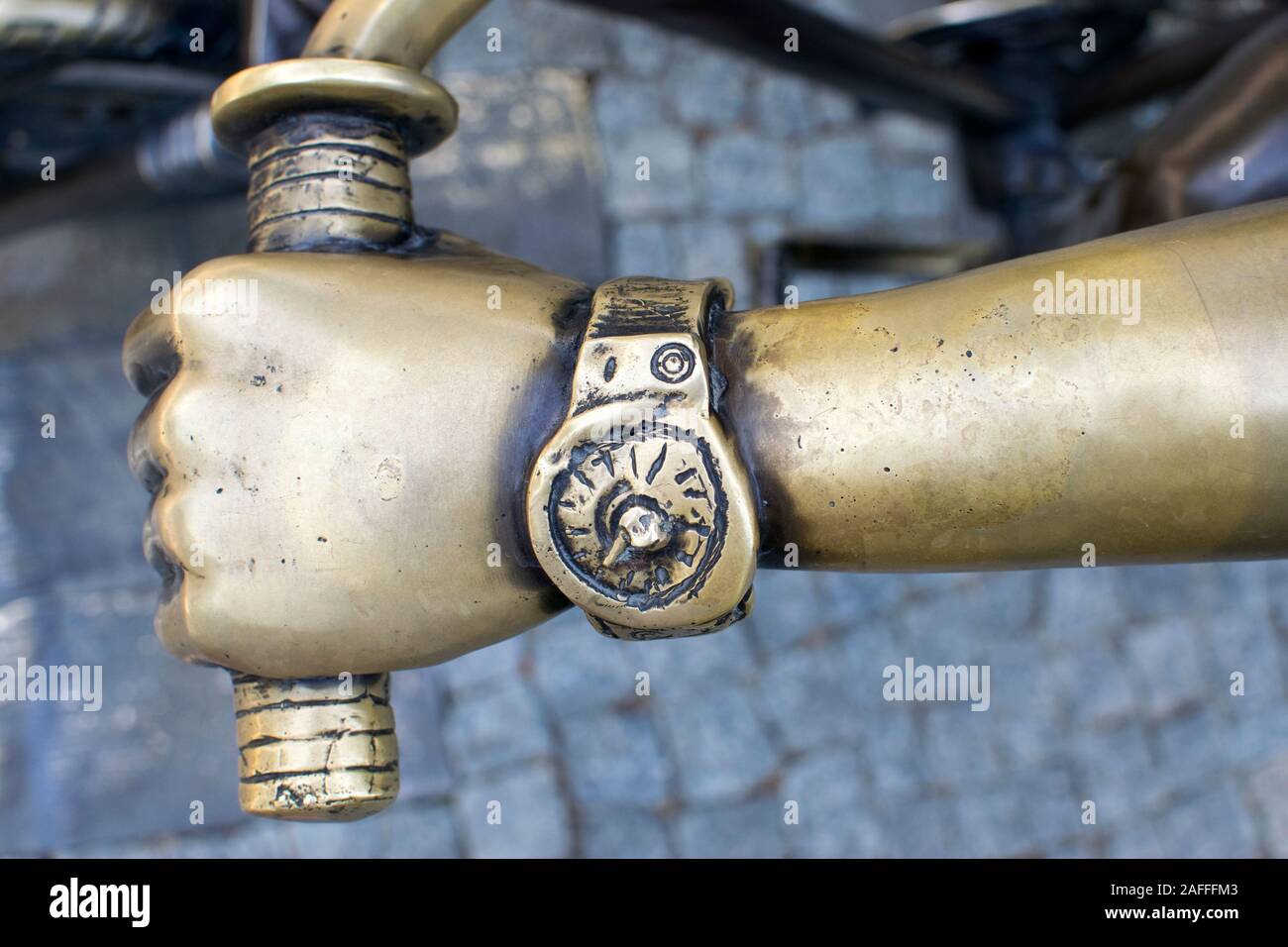 clock on the arm of a bronze statue of a boy. Wrist watch. Hand watch ...