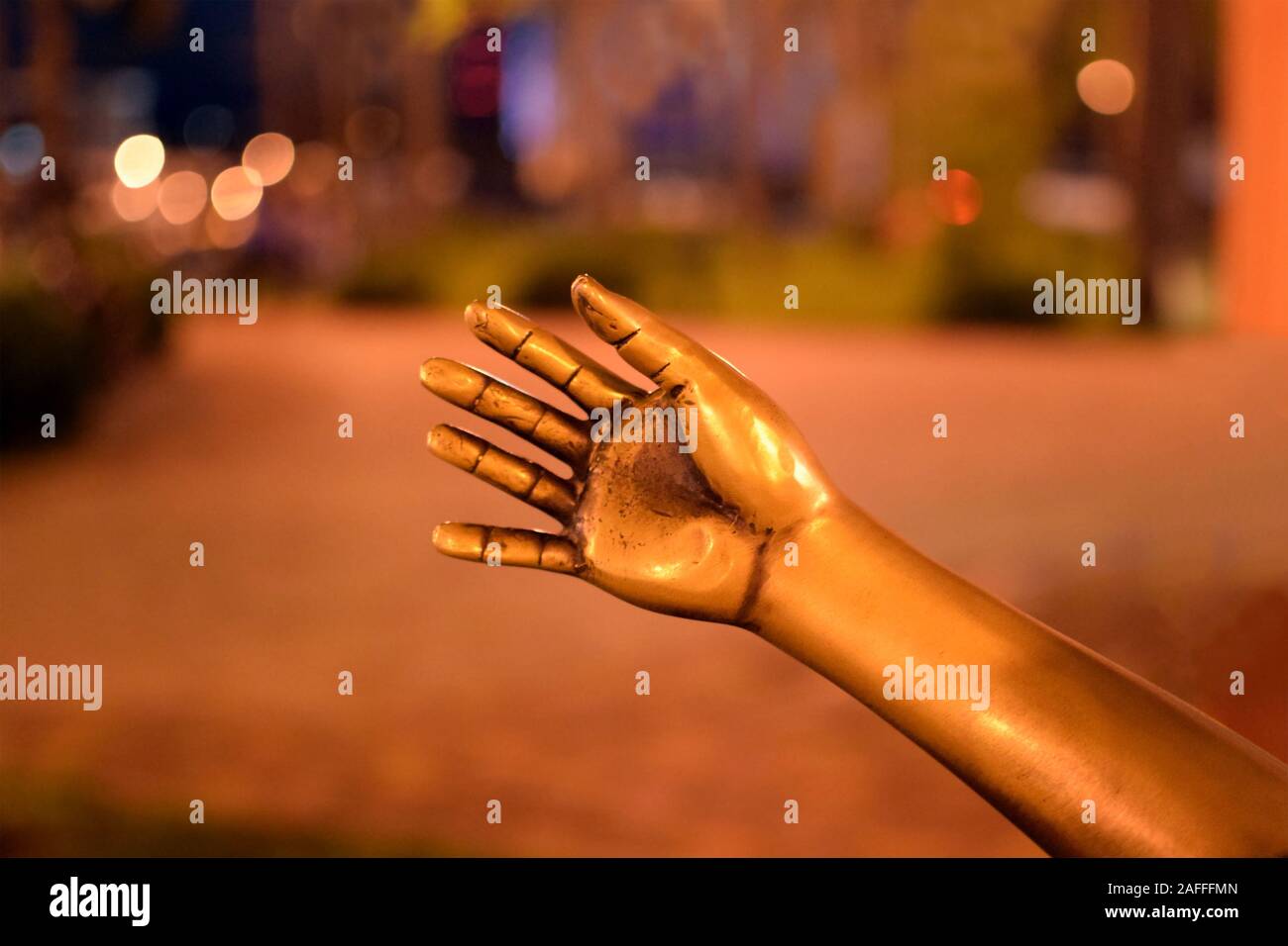 A fragment, the hand of a statue, a bronze hand reaching out to another ...