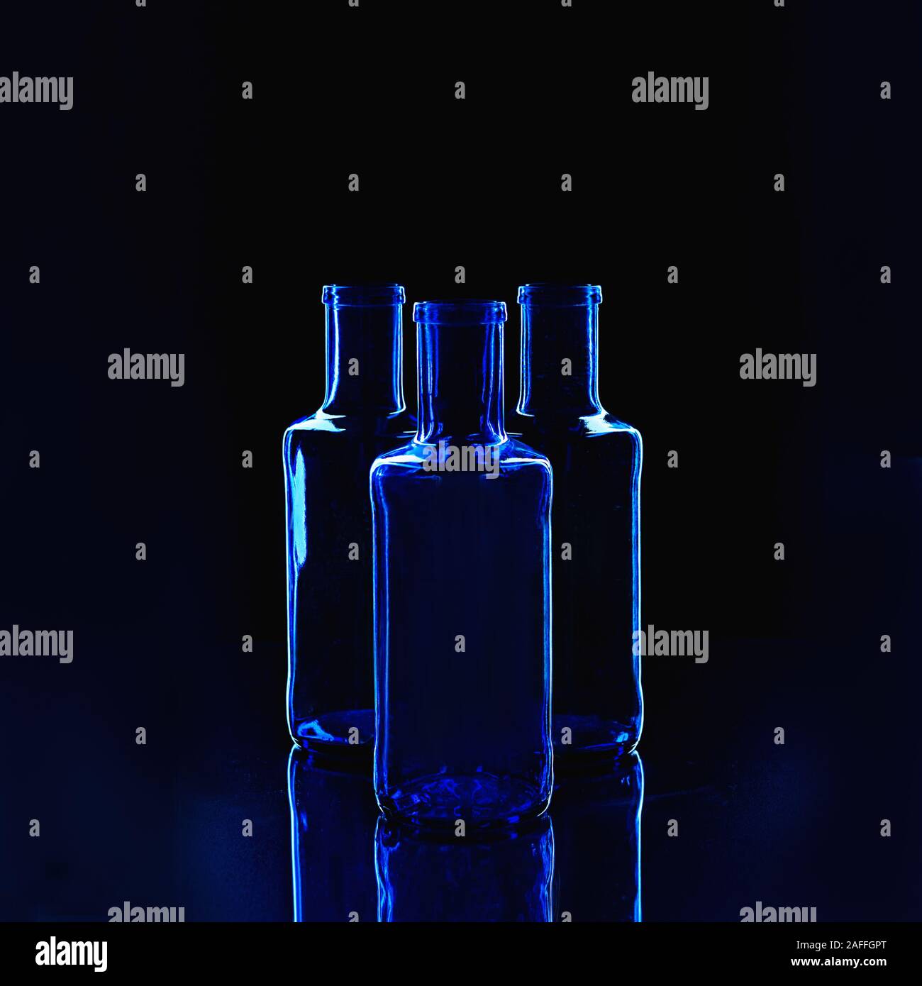 Empty classic blue color bottles isolated on dark background. Valentine ...