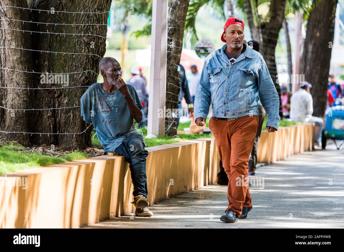Old man sitting in the crowd hi-res stock photography and images - Alamy