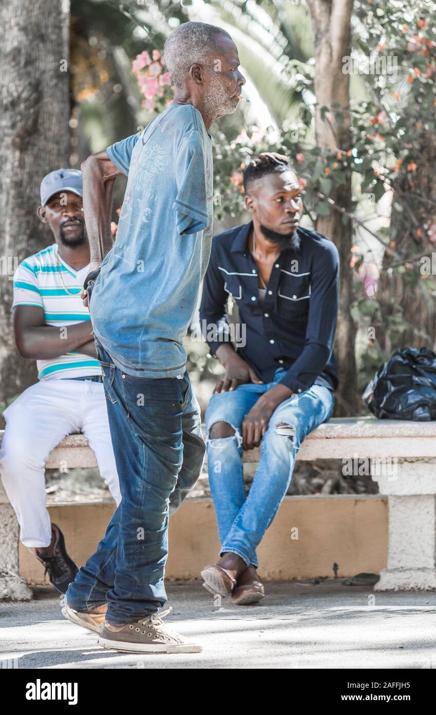 dramatic image of man walking in the park missing an arm smoking a ...