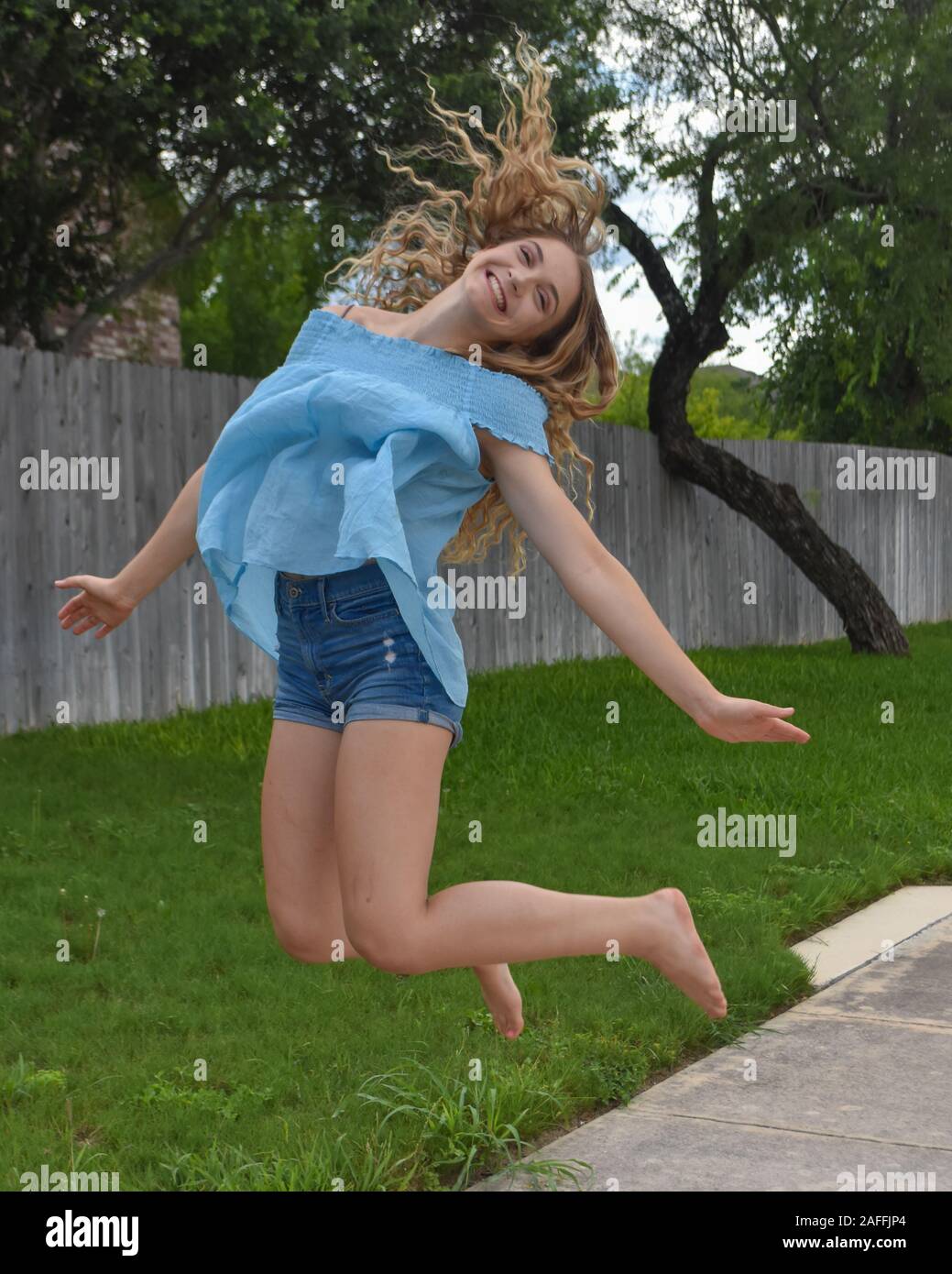 Teenage Girl Leaping for Joy Stock Photo - Alamy