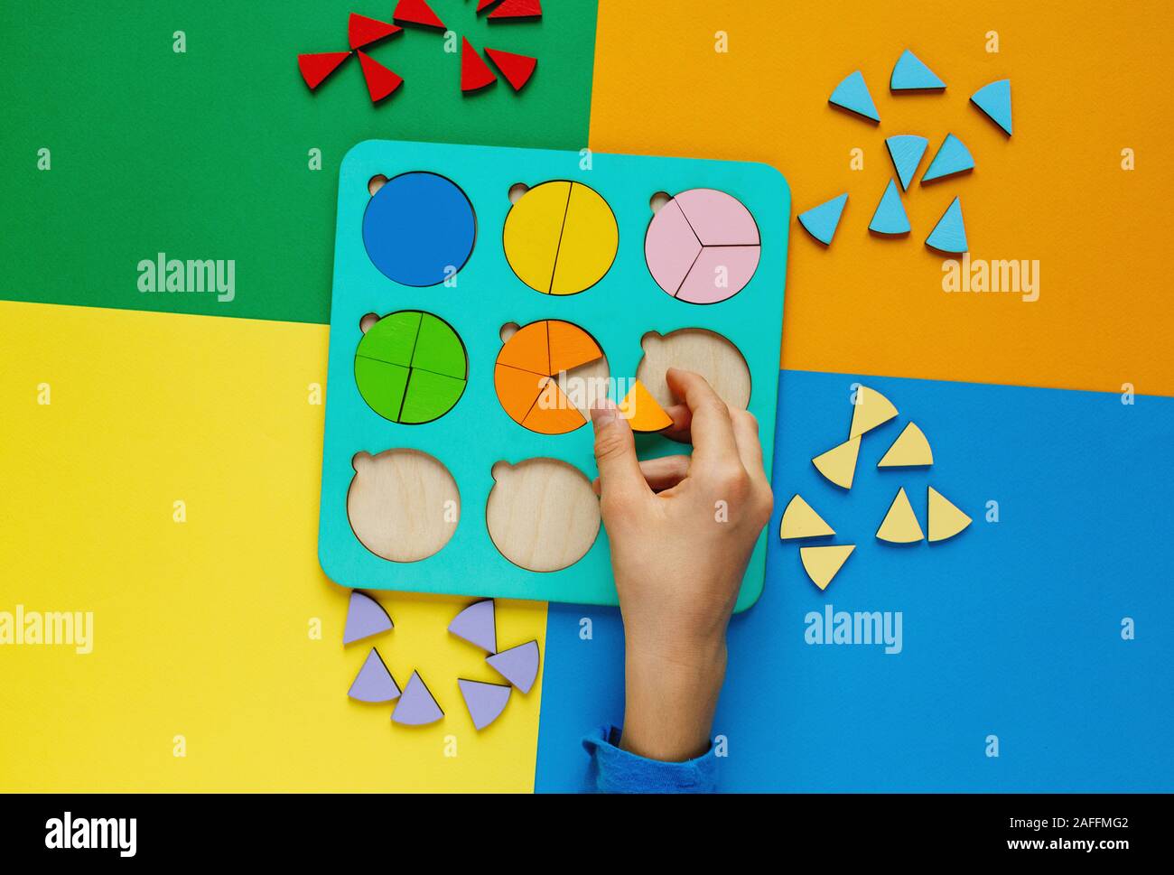 Wooden kids toys on colourful paper. Educational fractions. Toys for ...