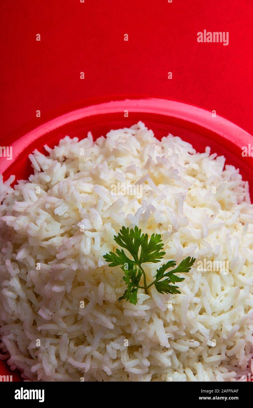 Cooked plain white basmati rice in a red plate on red background Stock ...