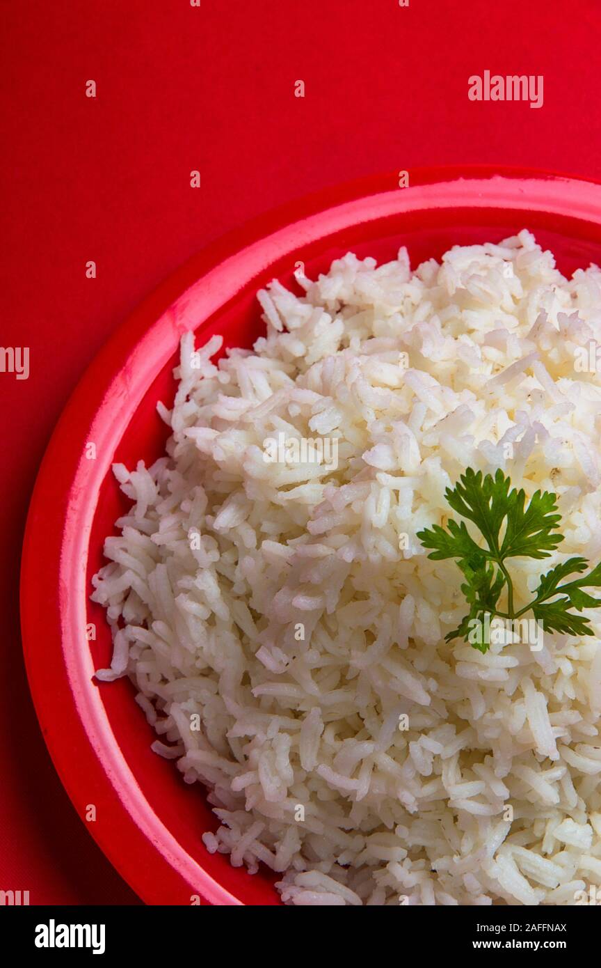 Cooked plain white basmati rice in a red plate on red background Stock ...