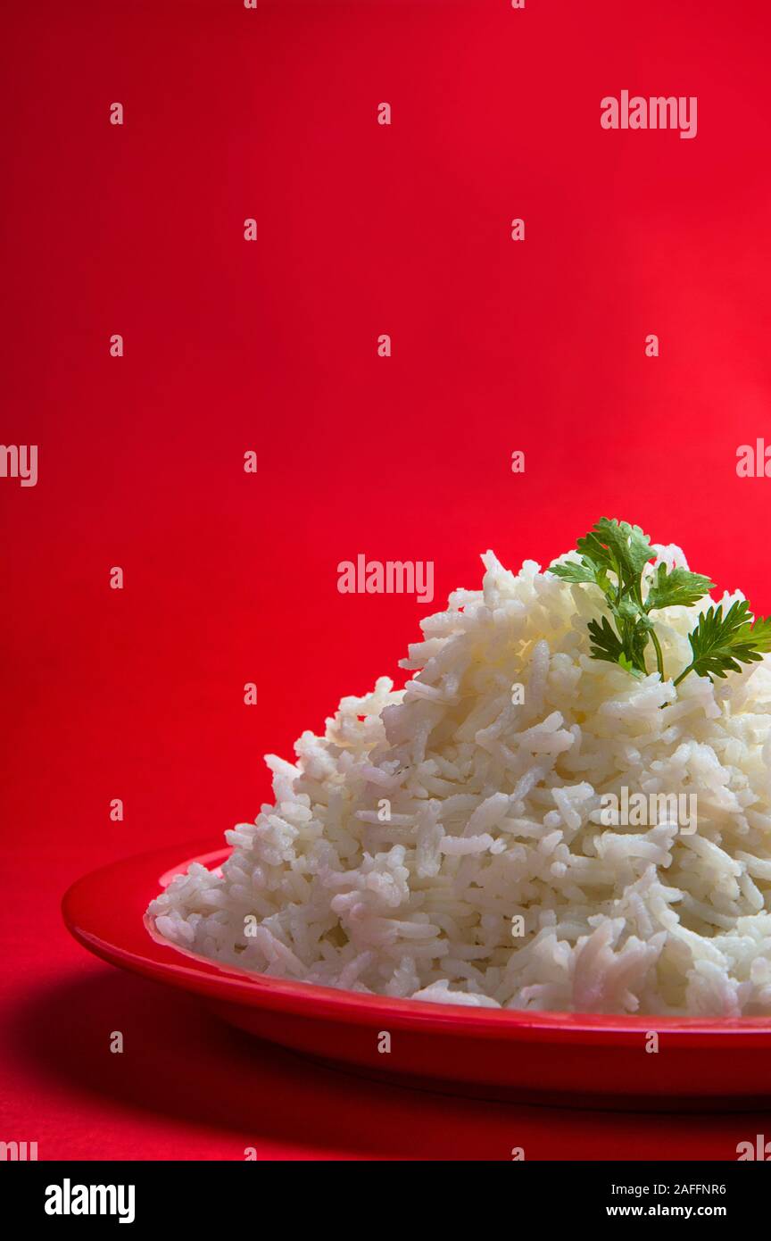 Cooked plain white basmati rice in a red plate on red background Stock ...
