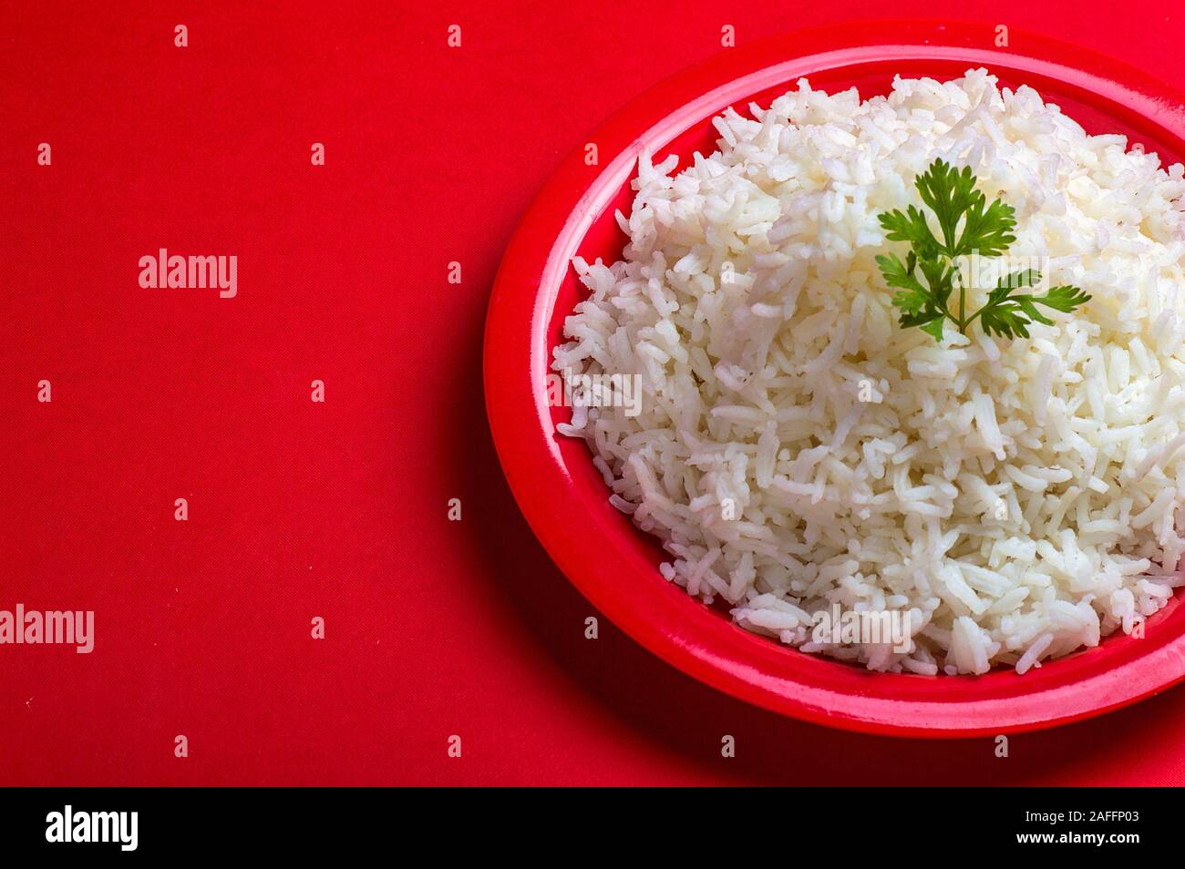 Cooked plain white basmati rice in a red plate on red background Stock ...