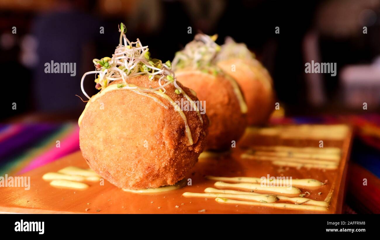 Ecuadorian bolon de verde or green plantain dumplings stuffed with ...