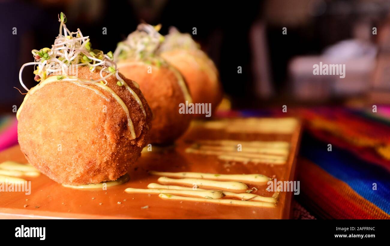 Ecuadorian bolon de verde or green plantain dumplings stuffed with ...
