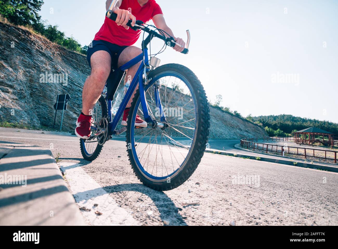 Fit male biker cyclist riding his bike cycle on an asphalt road at ...