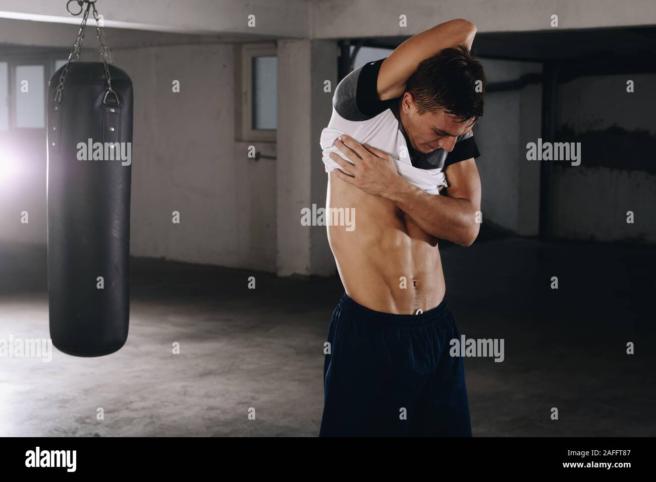 Sweaty man change clothes after hardwork training Stock Photo - Alamy