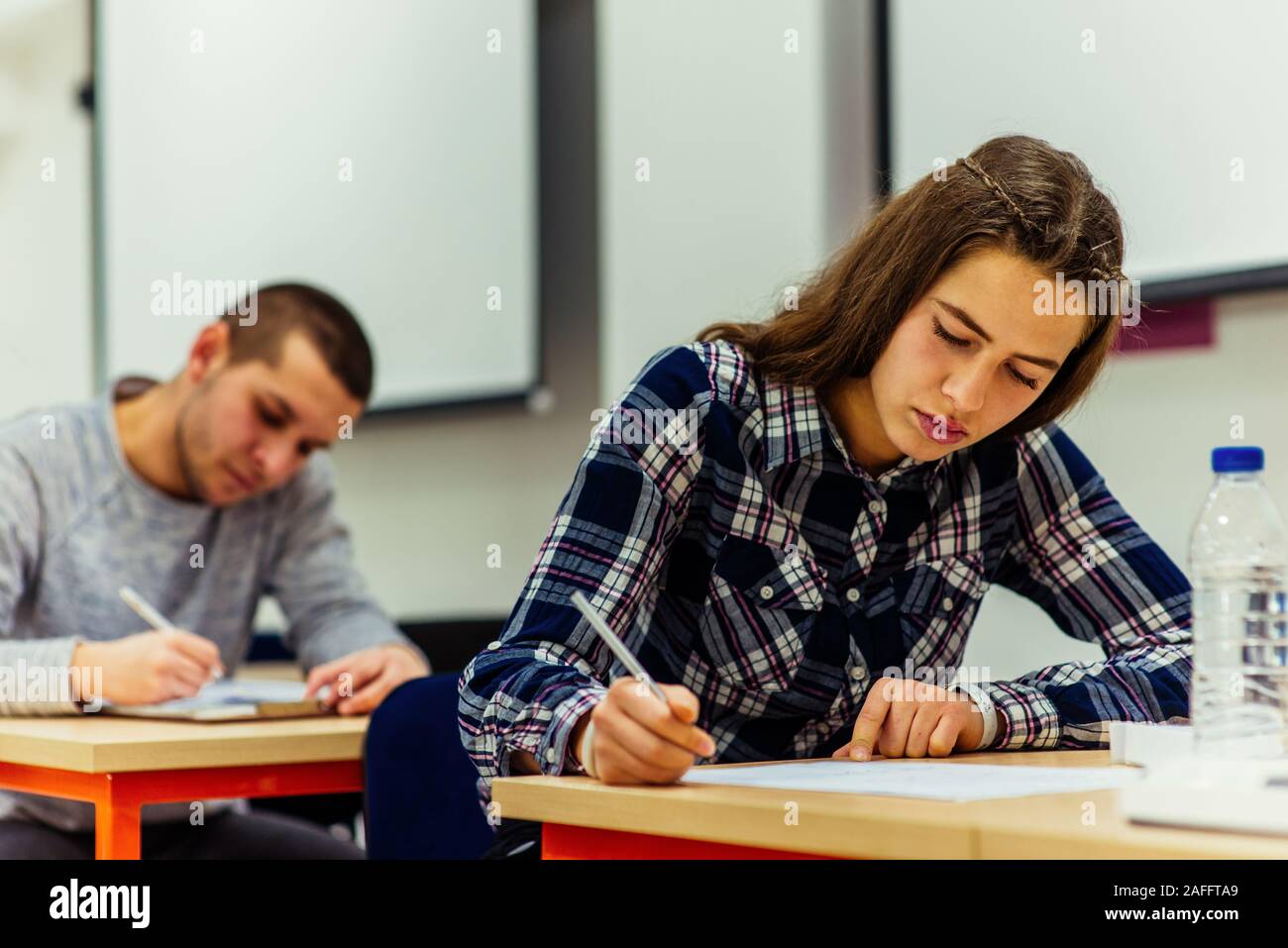 Knowledge testing of young students in classroom Stock Photo - Alamy