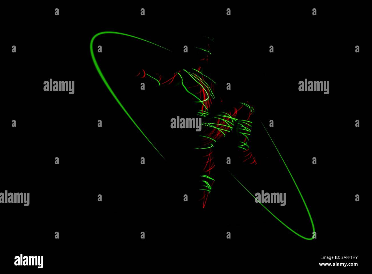 Laser beams silhouette of a dance artist performing a stylish dance ...