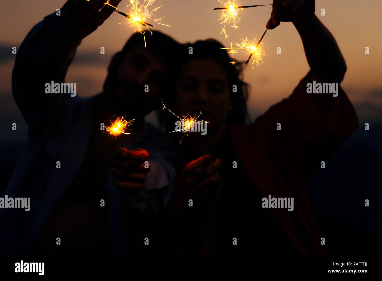 Group celebrating dusk silhouette hi-res stock photography and images ...