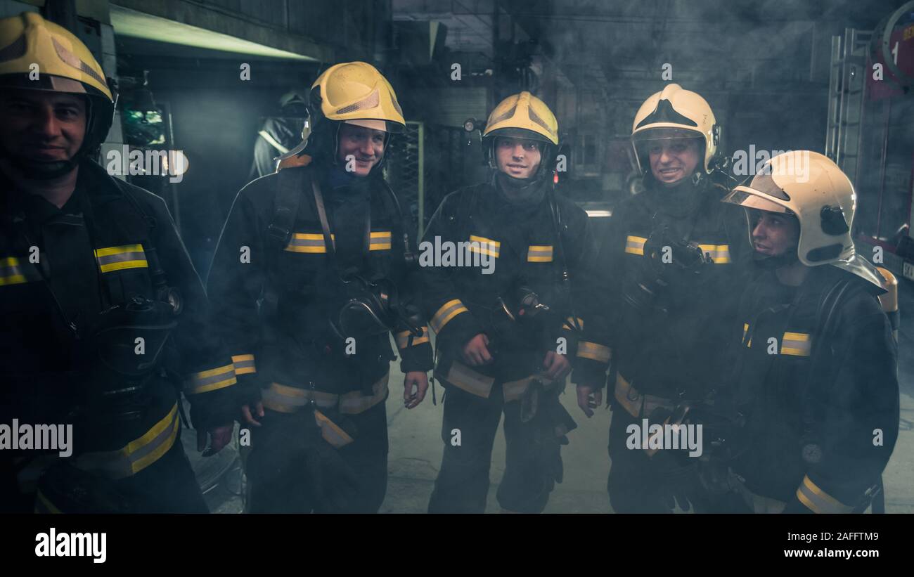 Team of firefighters standing inside ( indoors ) a buliding next to a ...