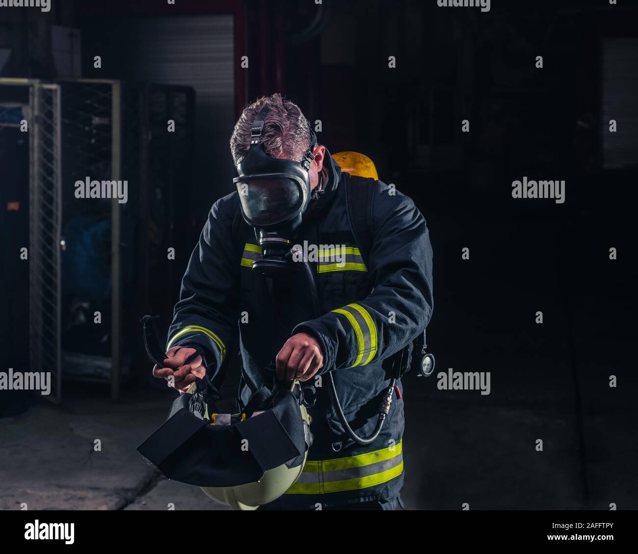 Firefighter with protective uniform wearing oxygen mask Stock Photo - Alamy