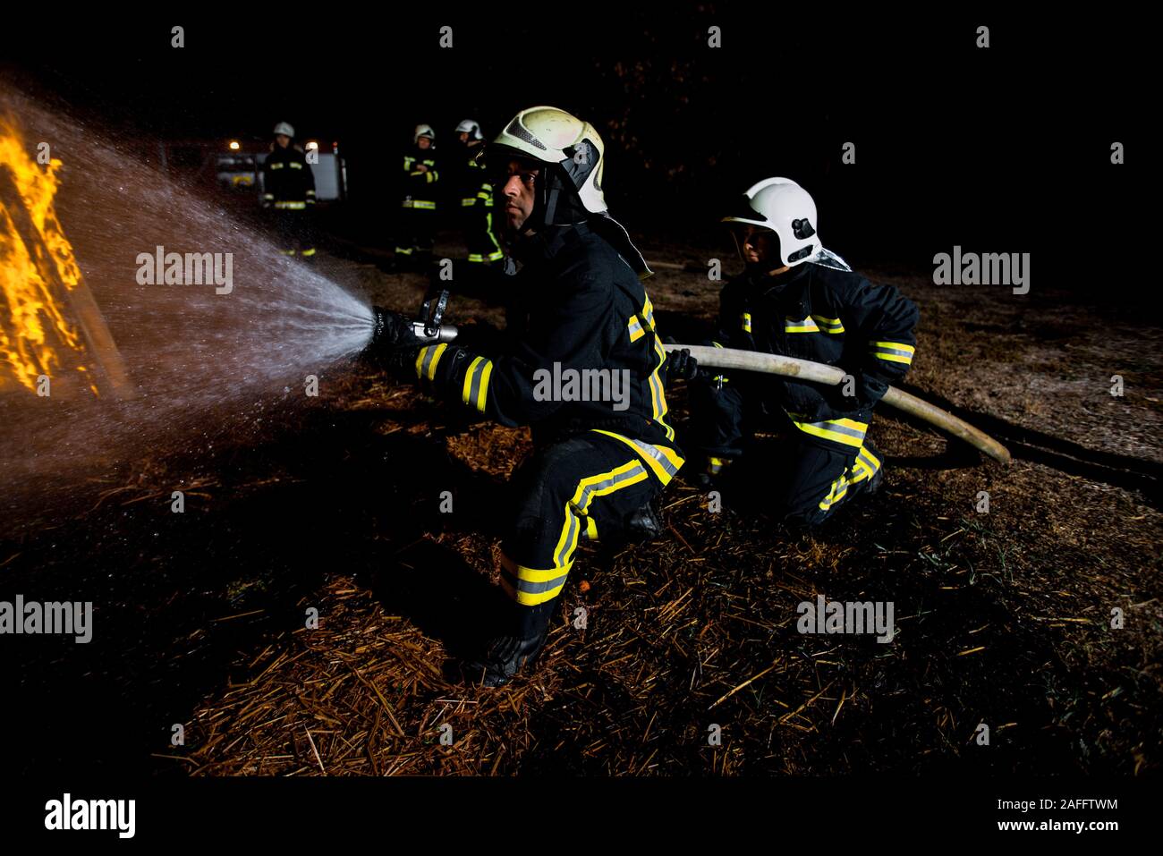 Firemen Using Hose High Resolution Stock Photography and Images - Alamy