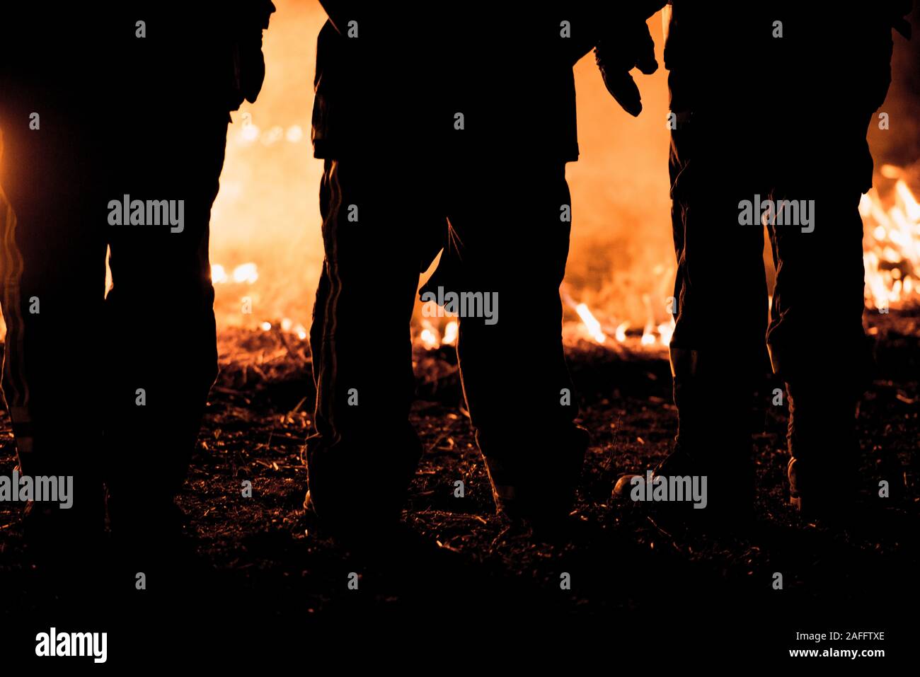 Firefighting group in action battling flames during night time Stock ...