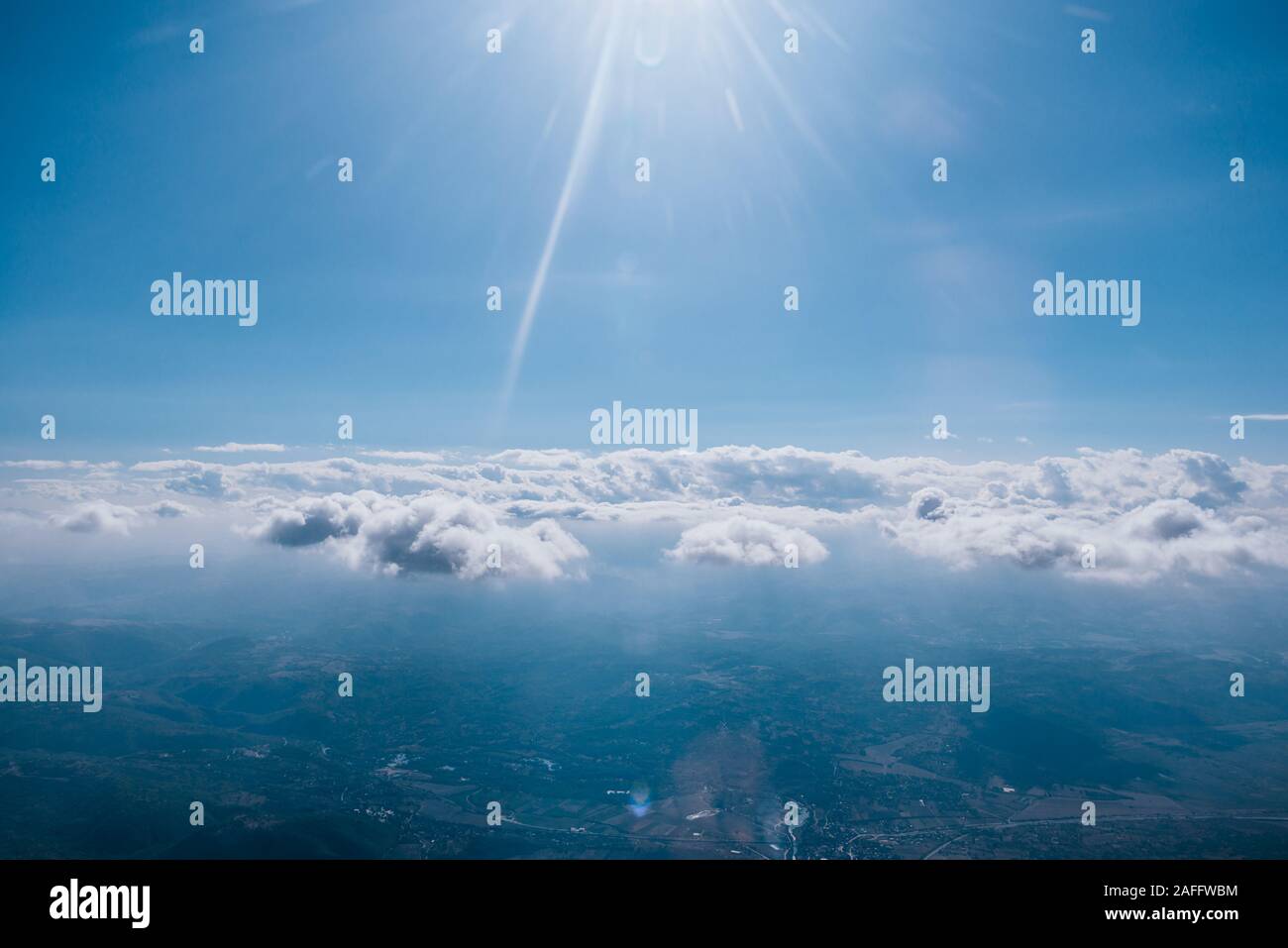 Sun rays shinning over a layer of clouds viewed from above Stock Photo ...