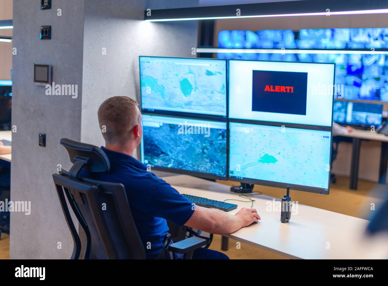 Male computer operator monitoring from a security ( computer, logistic ) center Stock Photo - Alamy