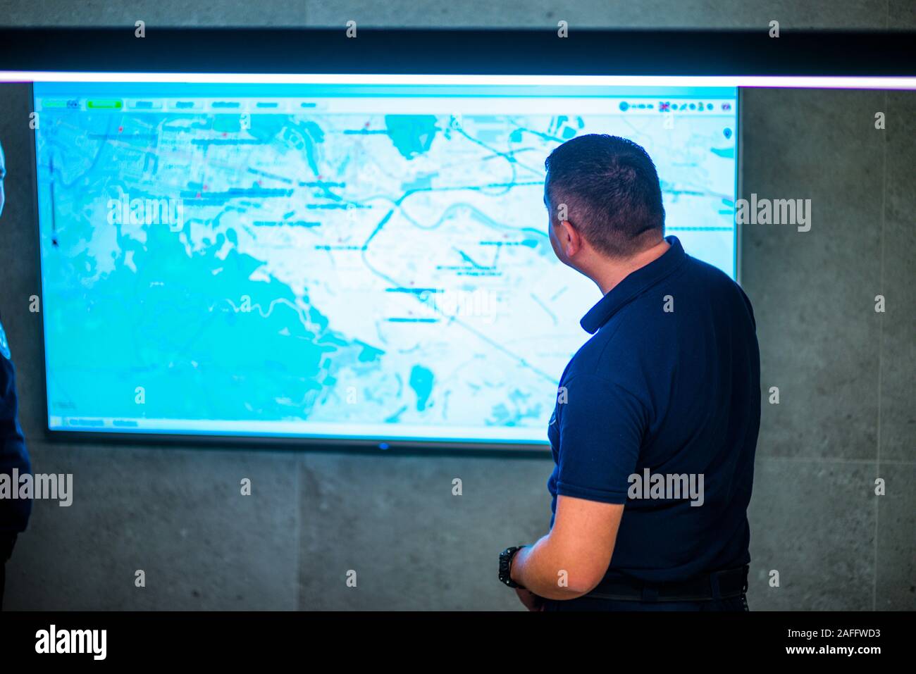 Security guards and policemen holdng portable transmitter having ...