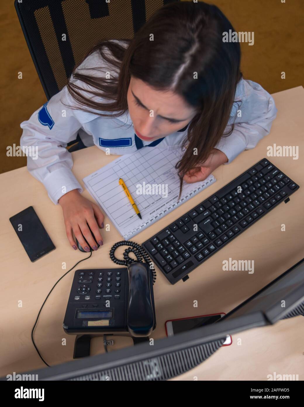 Female security guards working on computers while sitting in the main ...