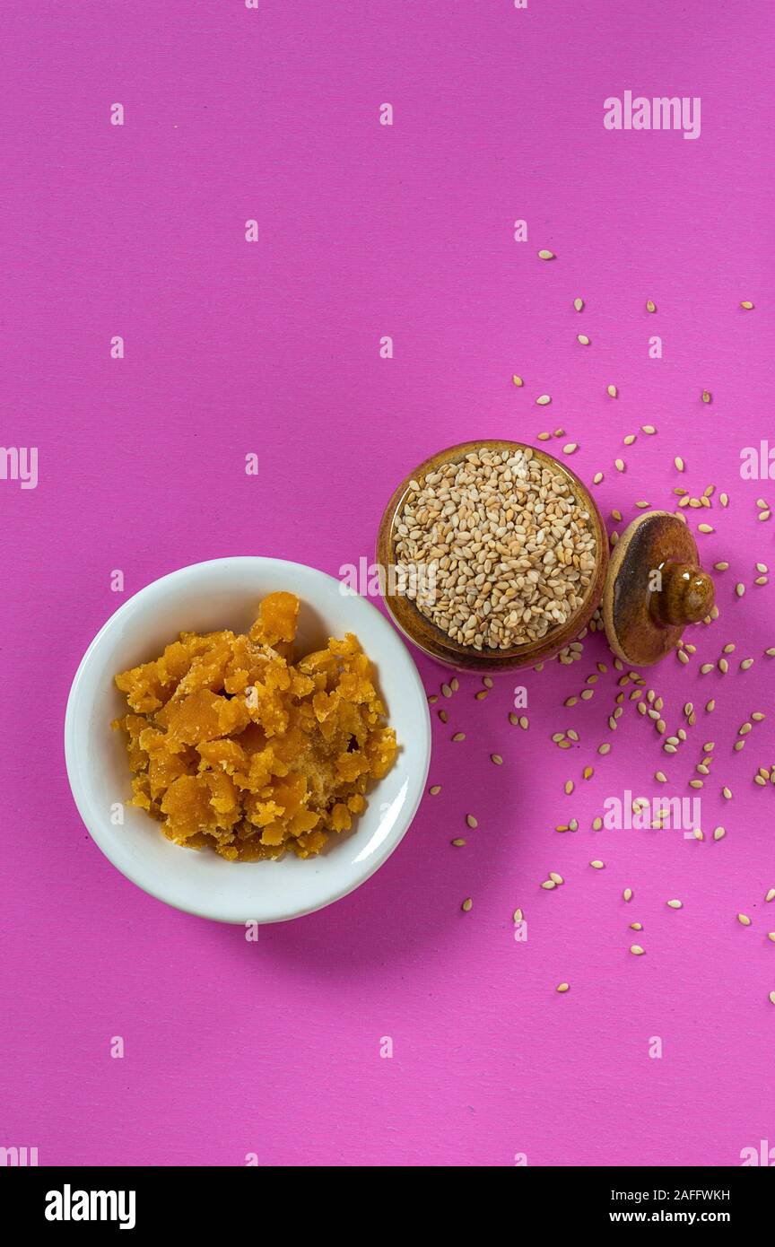 Sesame Seeds in clay pot with Jaggery in bowl on pink background Stock ...