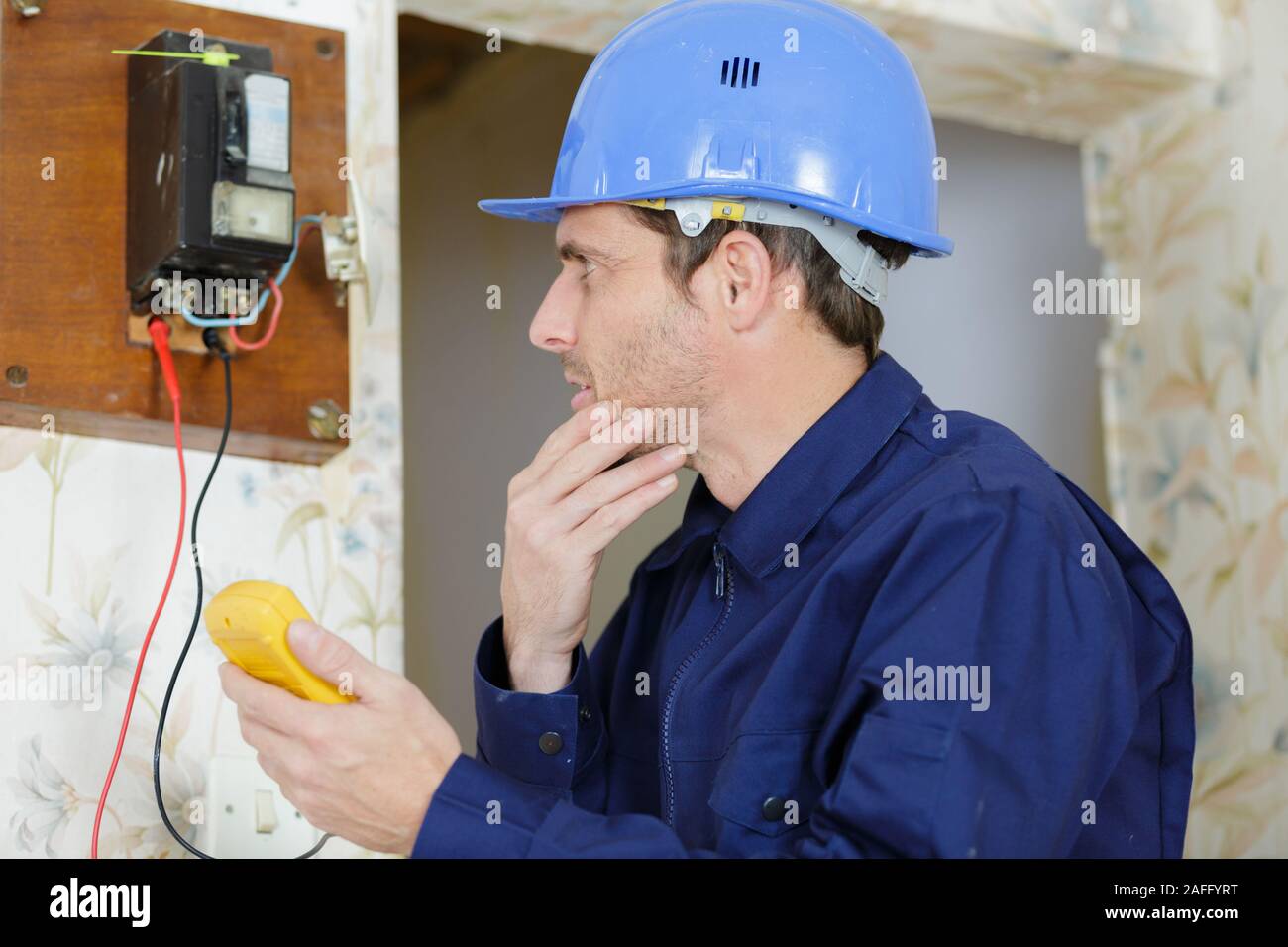 young electrician using a multimeter Stock Photo - Alamy