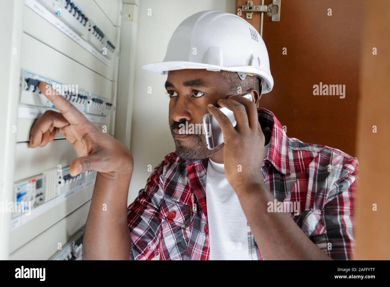 close-up of a man holding mobile phone reading electric meter Stock ...