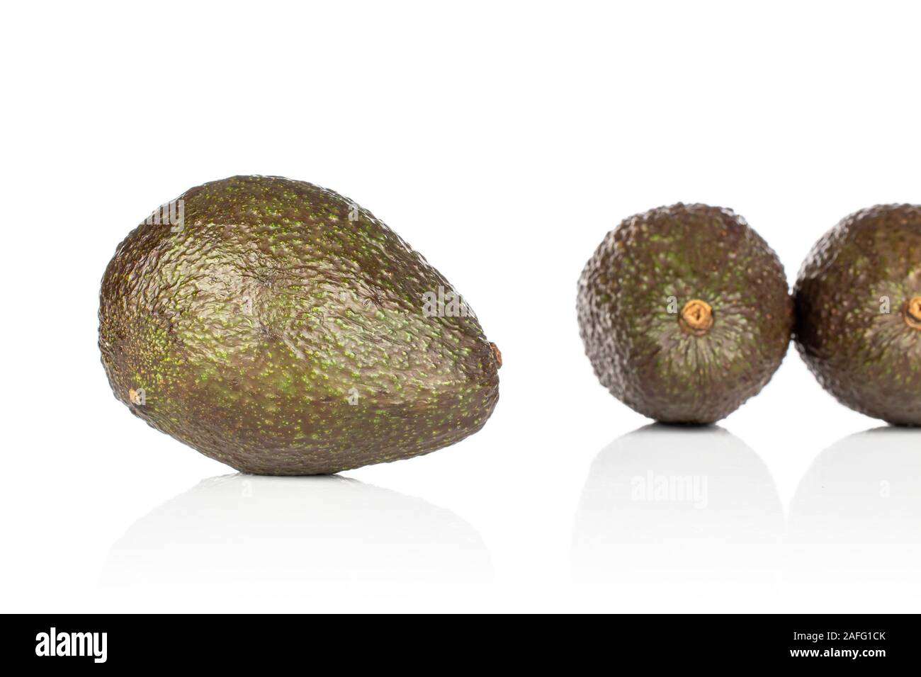 Group of three whole fresh green avocado isolated on white background ...