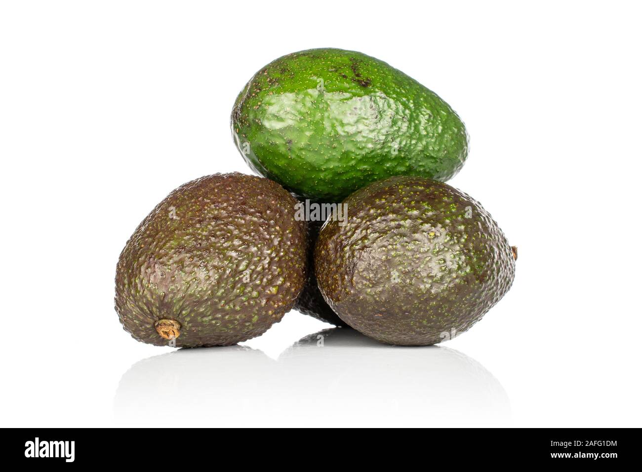 Group of three whole fresh green avocado heap isolated on white ...