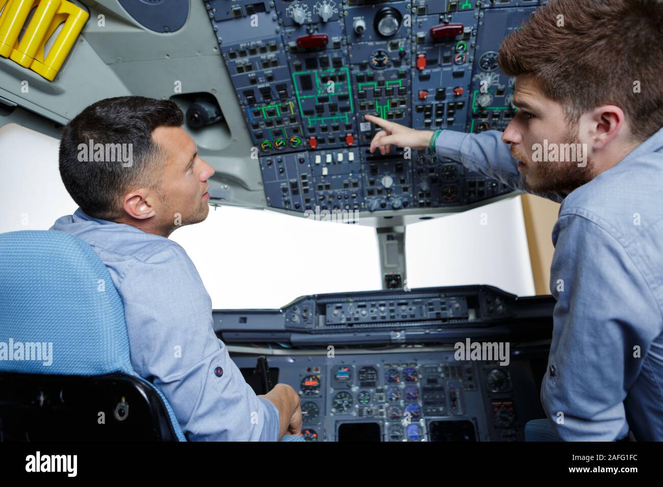 two men in aircraft cockpit apprentice asking a question Stock Photo ...