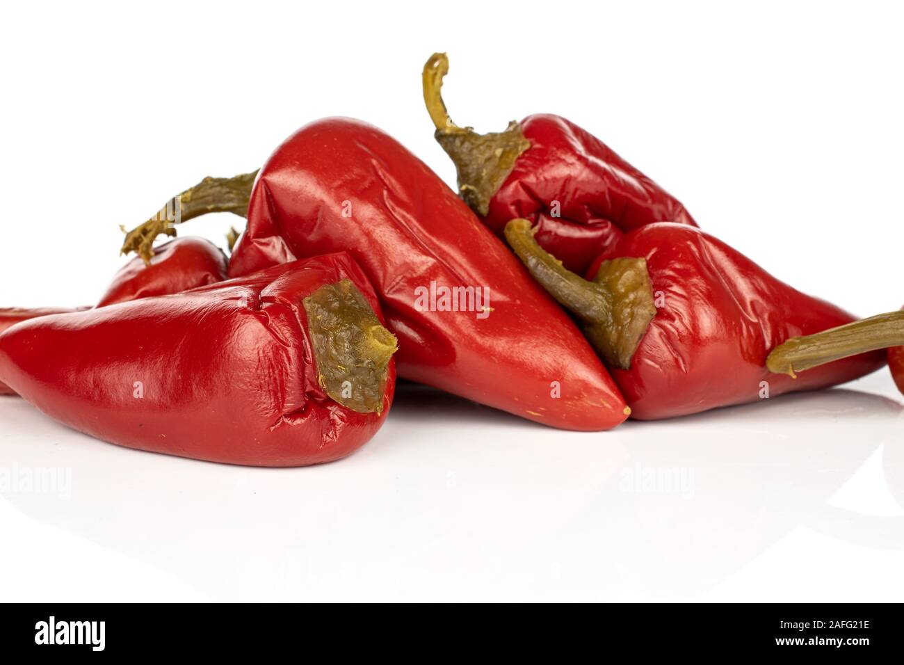 Group of five whole pickled red pepper stack isolated on white ...