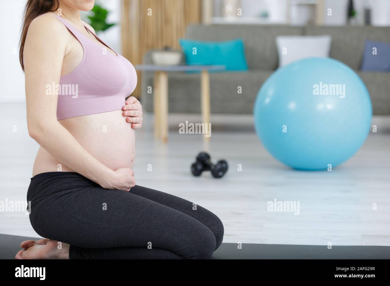 Woman hugging exercise ball hi-res stock photography and images - Alamy