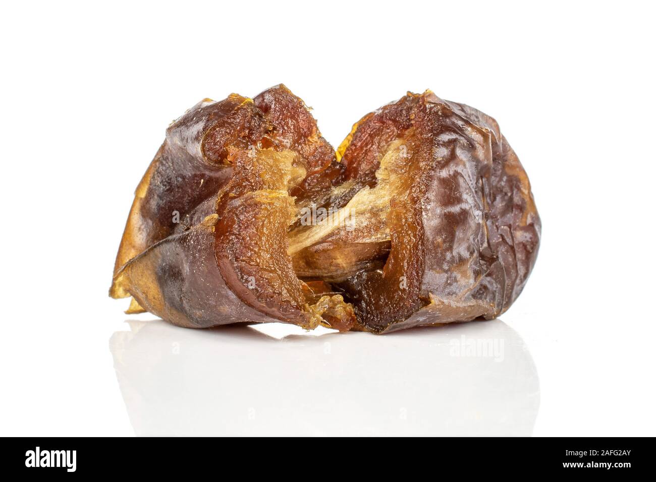 Group of two halves of dried brown date fruit one halved isolated on ...