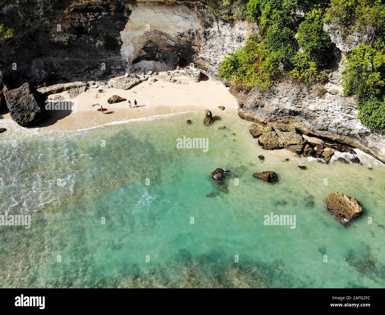 Aerial view of an amazing little beach with rock cliff in Bali ...