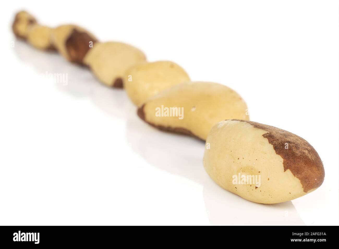 Group of seven whole brazil brown nut diagonal isolated on white ...