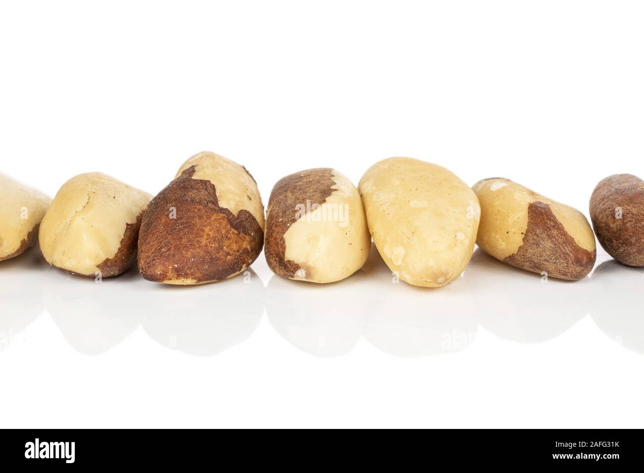 Group of seven whole brazil brown nut isolated on white background ...