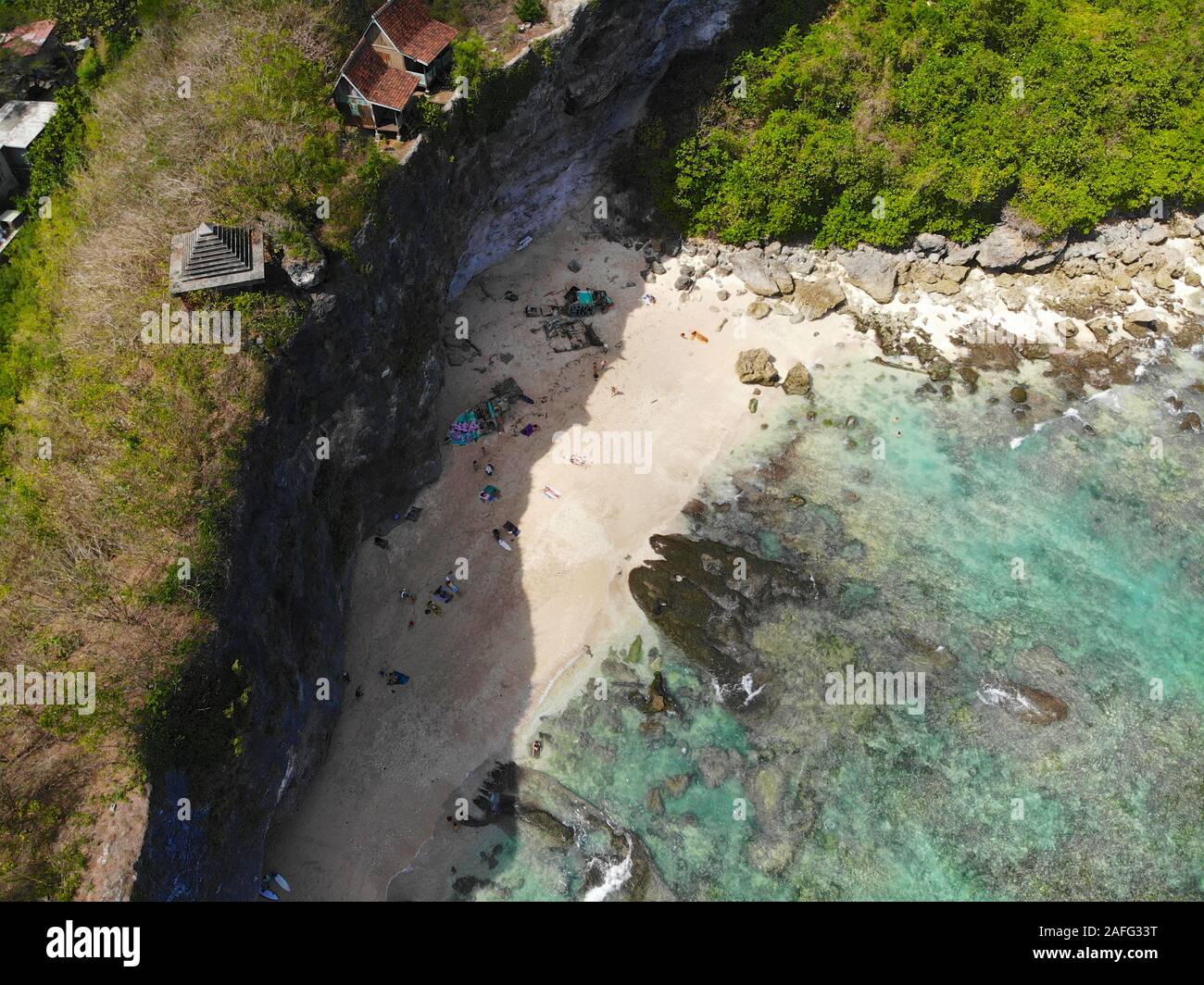 Aerial view of an amazing little beach with rock cliff in Bali ...