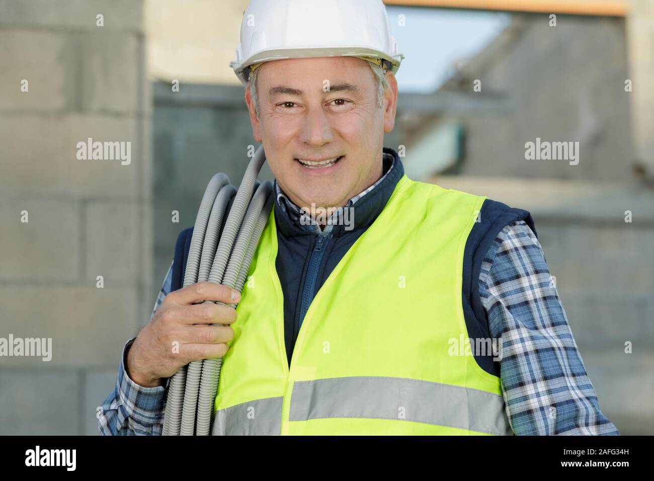 confident builder in electrical renovation site Stock Photo - Alamy