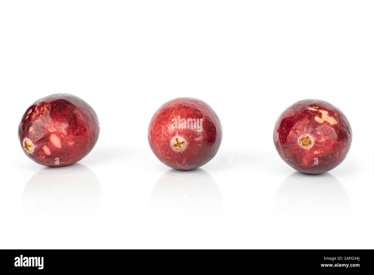 Group of three whole fresh red cranberry isolated on white background ...