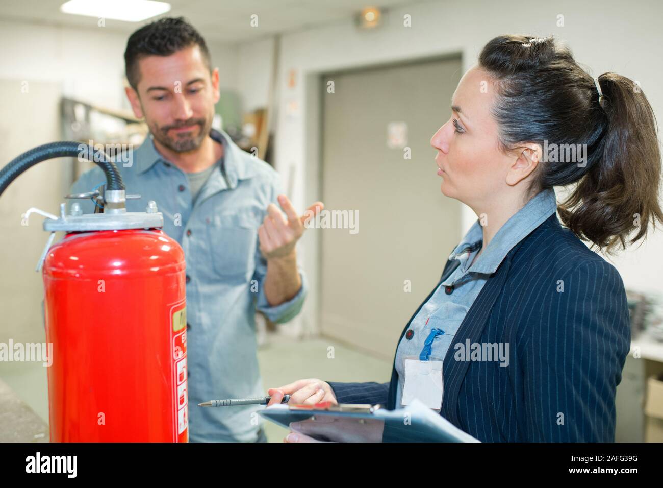 construction workers with fire extinguisher Stock Photo - Alamy