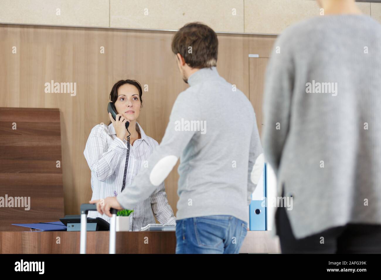 Young client at hotel reception hi-res stock photography and images - Alamy
